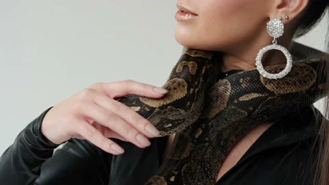 Snake on the neck of a woman in a black ... | Stock Video | Pond5