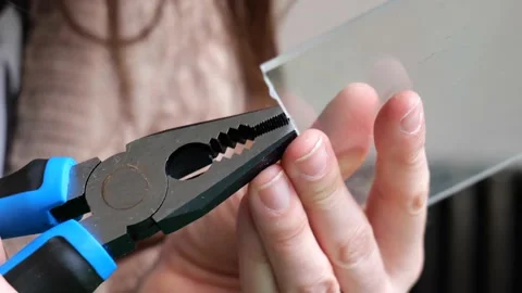 Snapping clear acrylic plastic with plie... | Stock Video | Pond5