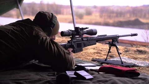 the sniper reloads the gun, takes aim an... | Stock Video | Pond5