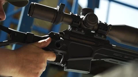 A sniper reloads a sniper rifle with an ... | Stock Video | Pond5