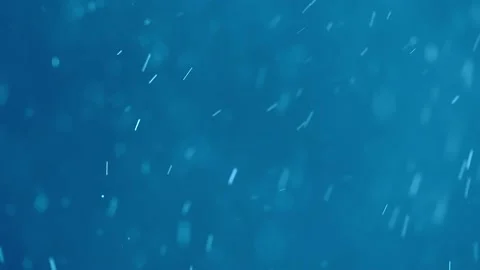 Snow is falling on a blue background in ... | Stock Video | Pond5