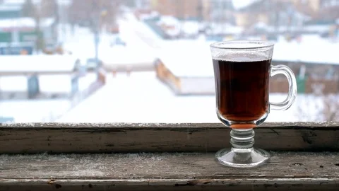 Snow falling on glass cup on old wooden ... | Stock Video | Pond5