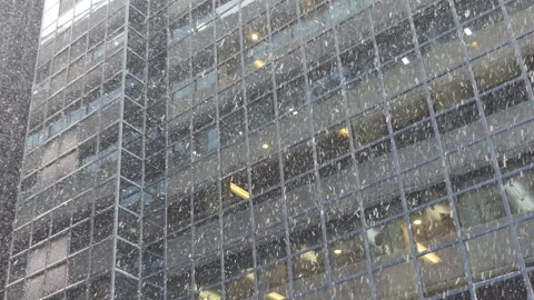 Snow falling on a street with an office ... | Stock Video | Pond5