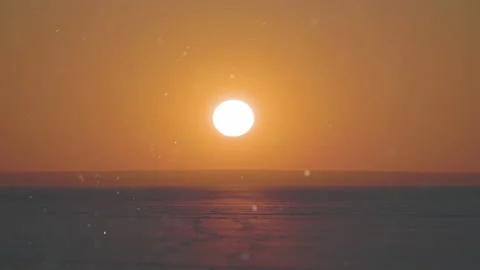 The snow falling on the sunset sky backg... | Stock Video | Pond5