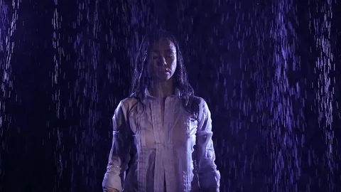 Soaking wet woman standing in the pourin... | Stock Video | Pond5