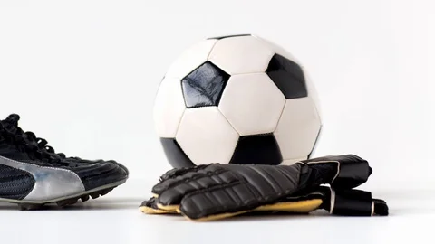 soccer ball, boots and gloves on white b... | Stock Video | Pond5