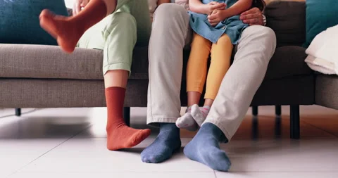 Socks of mom, dad and kid on sofa with l... | Stock Video | Pond5