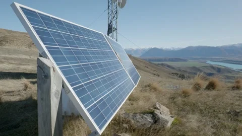 Solar panel and transmission tower on mo... | Stock Video | Pond5