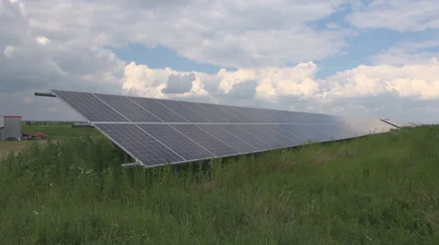 Solar panels placed on a green field bac... | Stock Video | Pond5