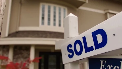 Sold sign in front of a modern home | Stock Video | Pond5