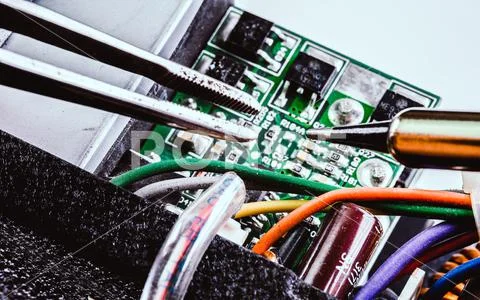 Soldering the microcircuit using a soldering iron Stock Photo #161128070