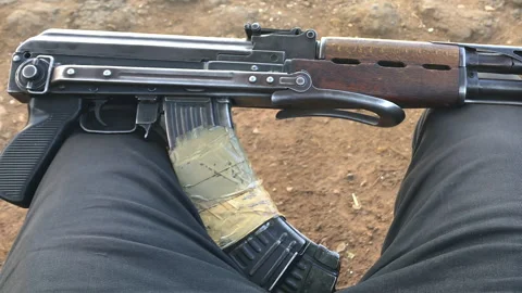 Soldier in Africa is holding old AK-47 o... | Stock Video | Pond5