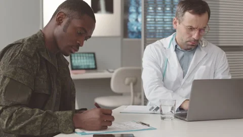 Soldier Filling Out Medical Form at Doct... | Stock Video | Pond5