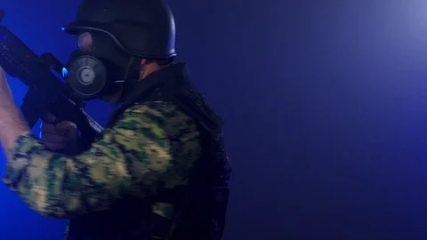 Soldier in gas mask turns around and poi... | Stock Video | Pond5