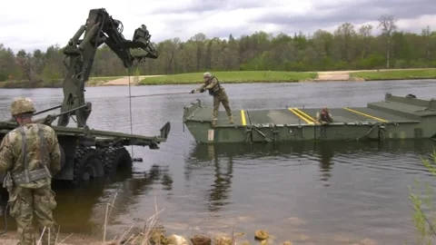 Soldier grabs cable on M1977 CBT for lif... | Stock Video | Pond5