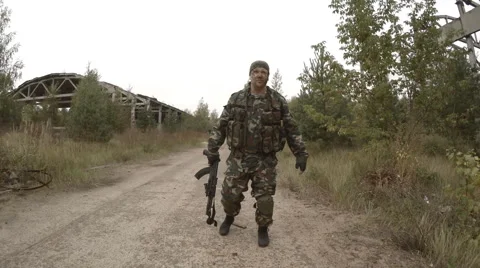 soldier with gun walking on concrete roa... | Stock Video | Pond5