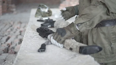 soldier keeps a muffler on gunmachine | Stock Video | Pond5