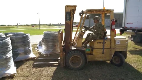 Soldier operates forklift to move pallet... | Stock Video | Pond5