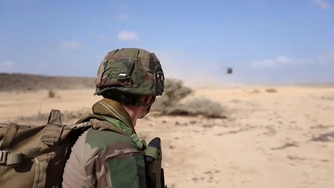 Soldier waiting for arrival of Blackhawk... | Stock Video | Pond5