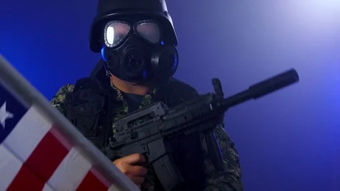 Soldier wearing gas mask holds rifle and... | Stock Video | Pond5