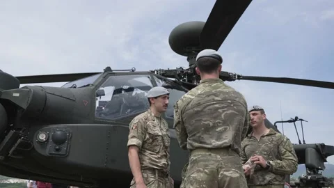 Soldiers and Apache attack helicopter ch... | Stock Video | Pond5