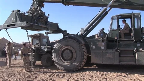 Soldiers attach transport chain to vehic... | Stock Video | Pond5