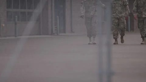 Soldiers Behind a Gate Walking and Talki... | Stock Video | Pond5