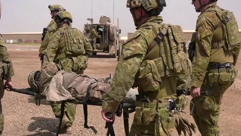 soldiers carry casualty on stretcher to ... | Stock Video | Pond5