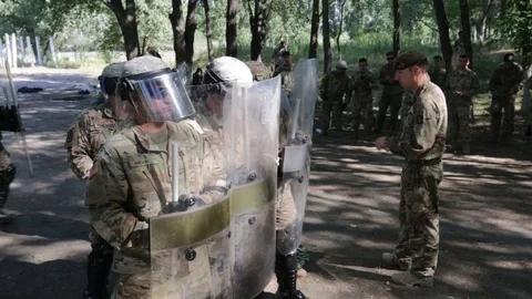 Soldiers form wall with riot shields dur... | Stock Video | Pond5