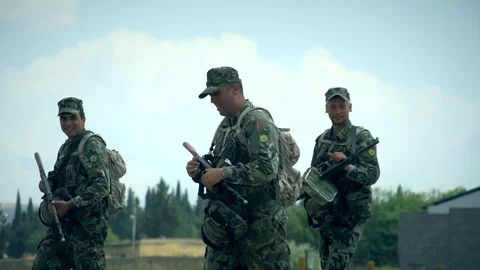 Soldiers with machine gun walk during Ag... | Stock Video | Pond5