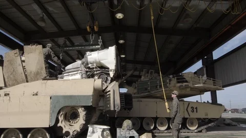 Soldiers remove an Abrams tank engine in... | Stock Video | Pond5