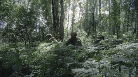 Soldiers with weapons, in an ambush in a... | Stock Video | Pond5