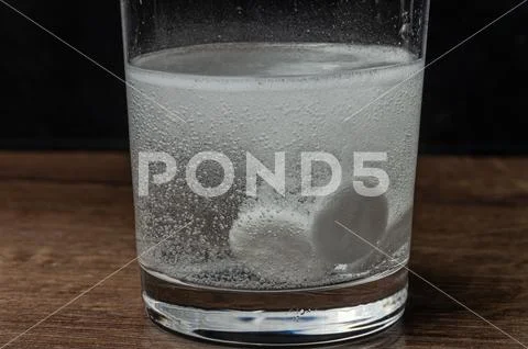 Photograph: Soluble effervescent tablets dissolve in water. #273509717