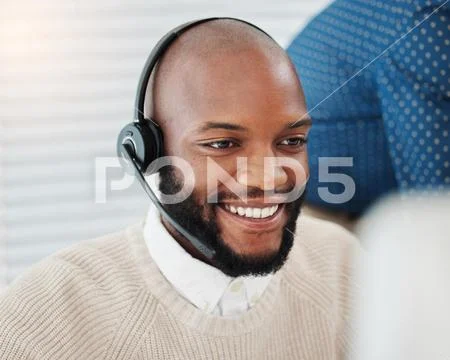 Photograph: Solving each query with a smile. a handsome young salesman ...