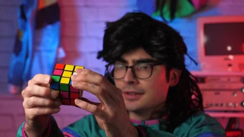 Solving a Rubik Cube in the 80s 90s Retr... | Stock Video | Pond5