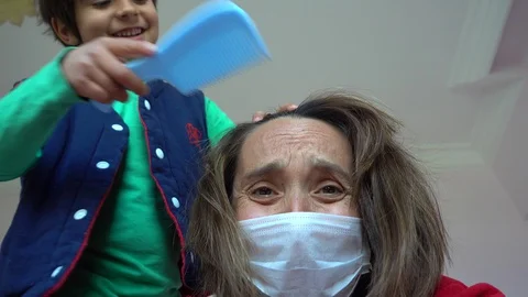 Son combs hair of his crying mother in m... | Stock Video | Pond5