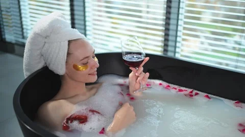 Spa relaxation. Woman lying in bath with... | Stock Video | Pond5