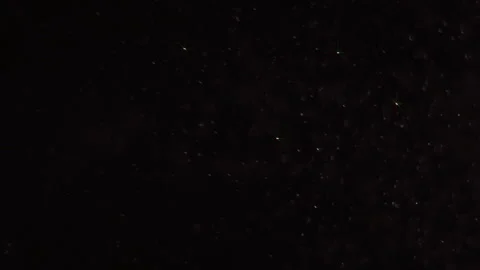 Sparkling dust particles falling on blac... | Stock Video | Pond5