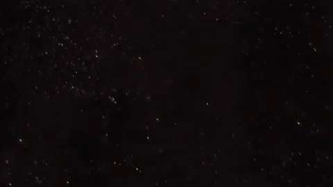 Sparkling dust particles falling on blac... | Stock Video | Pond5