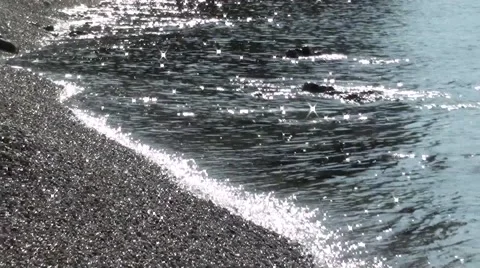 Sparkling sea water and pebble beach | Stock Video | Pond5