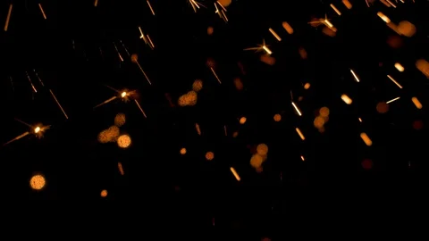 Sparks falling on black background | Stock Video | Pond5