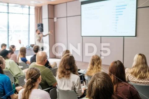 Speaker presenting to audience in modern conference room setup Stock ...