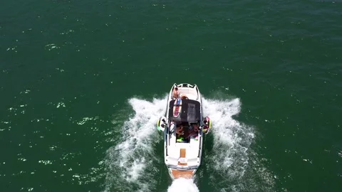 Speed boat with people roaring across th... | Stock Video | Pond5