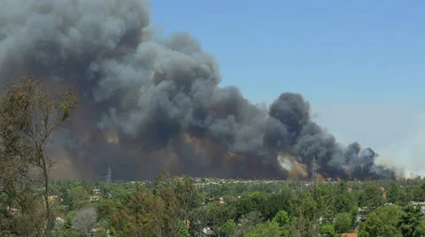 Speed Up of Fire and smoke behind homes.... | Stock Video | Pond5