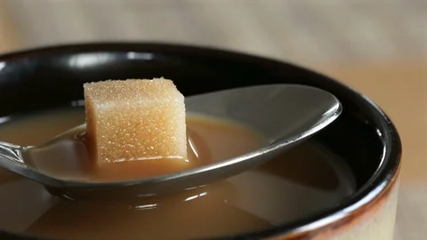 Speeded up sugar cube dissolving in tea ... | Stock Video | Pond5