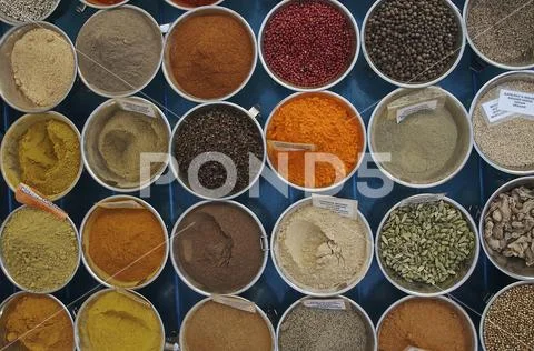 Spice mixture in round containers as powder and as fruit top view from ...