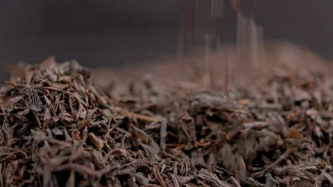 spinning and falling dry black tea close... | Stock Video | Pond5