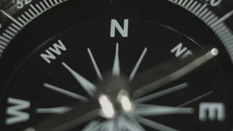 Spinning compass arrow pointing to North | Stock Video | Pond5
