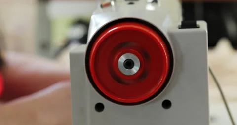 spinning red flywheel of a sewing machin... | Stock Video | Pond5