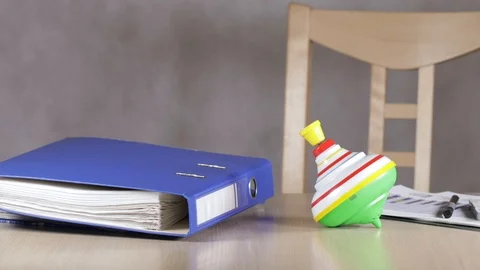 Spinning top is moving on office table. | Stock Video | Pond5